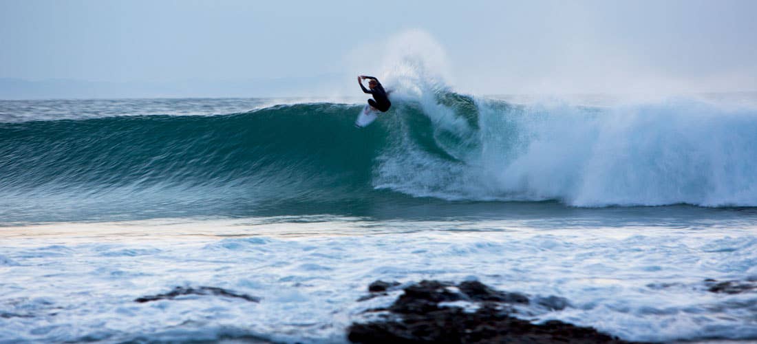 Shark Following Surfer In Wave