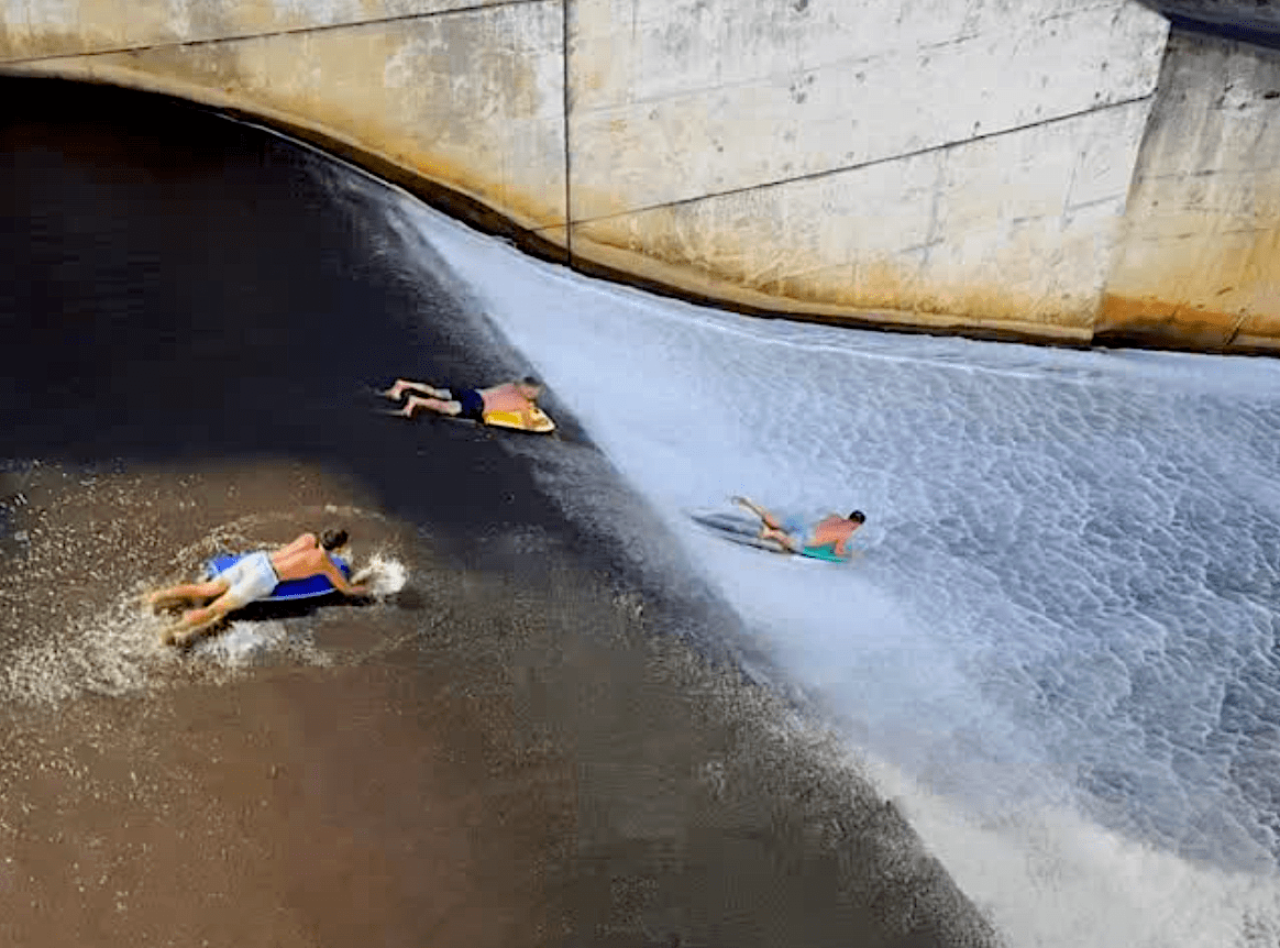Dam Surfers Ride Giant ‘Illegal Waterslide’ in Australia (Video) - Surfer